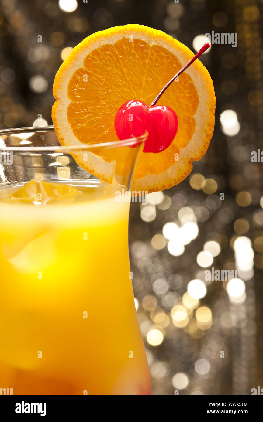 Tequila sunrise Cocktail in front of different colored backgrounds ...