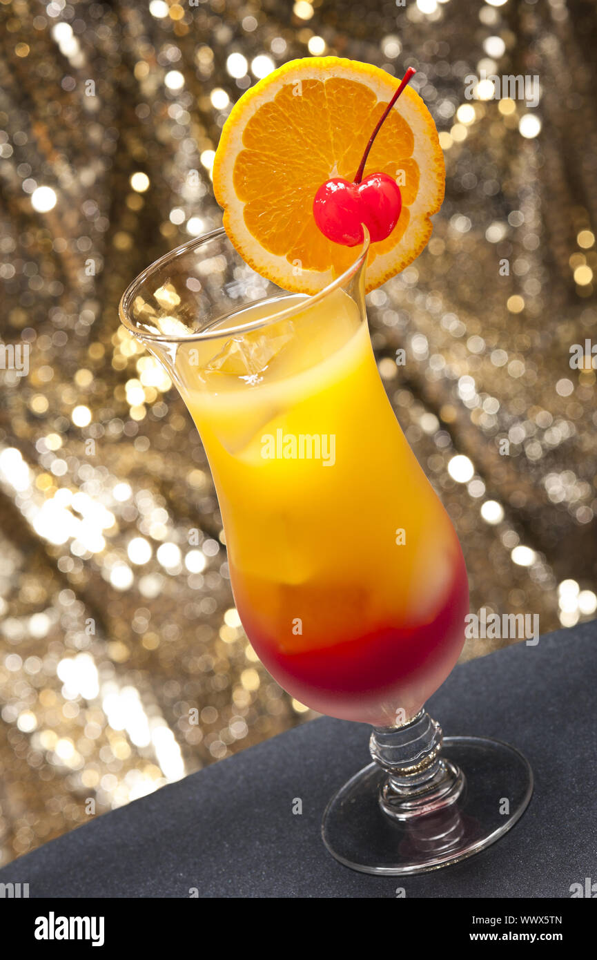 Tequila sunrise Cocktail in front of different colored backgrounds ...