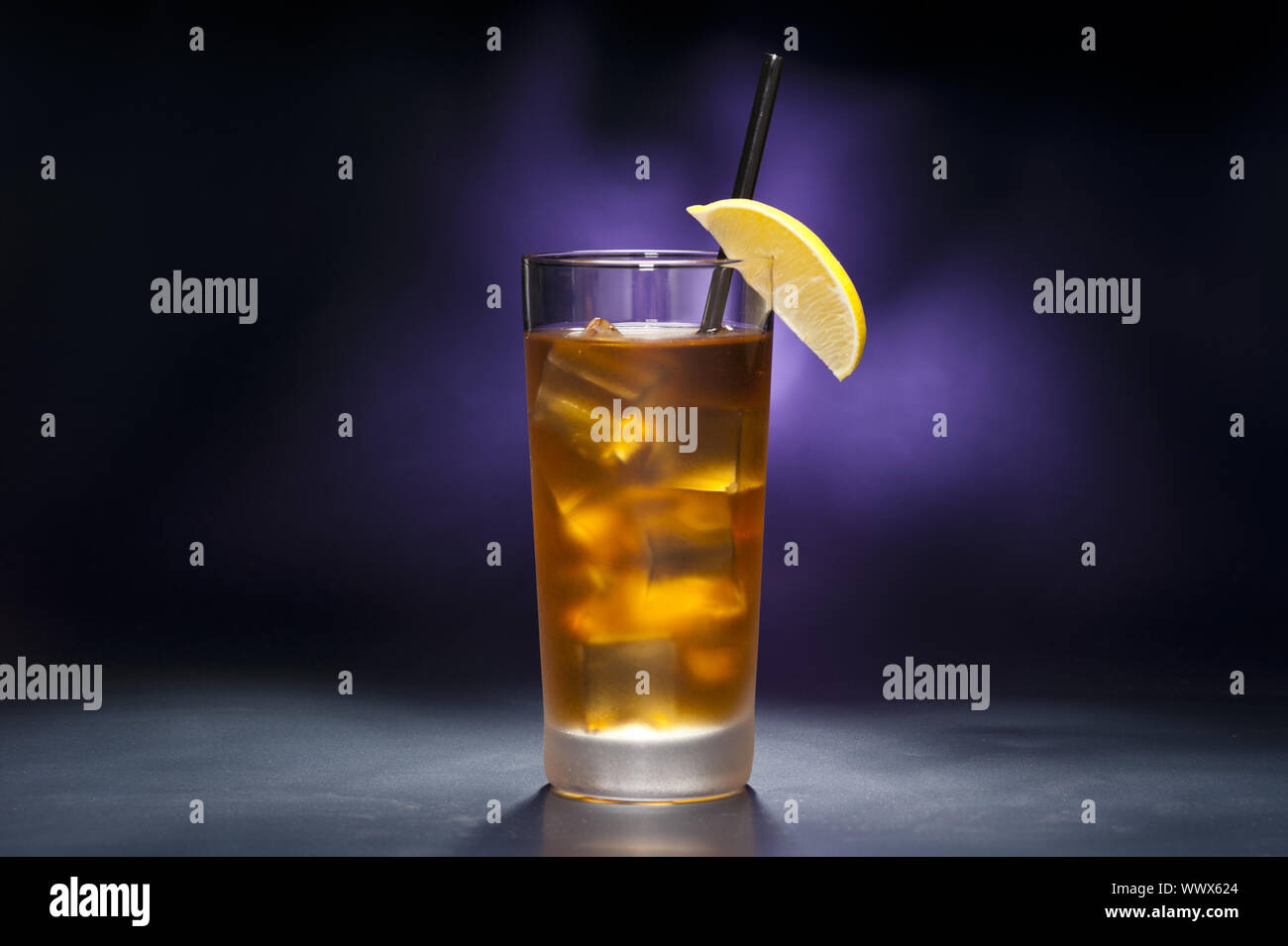 Long Island Iced tea in front of purple background Stock Photo - Alamy