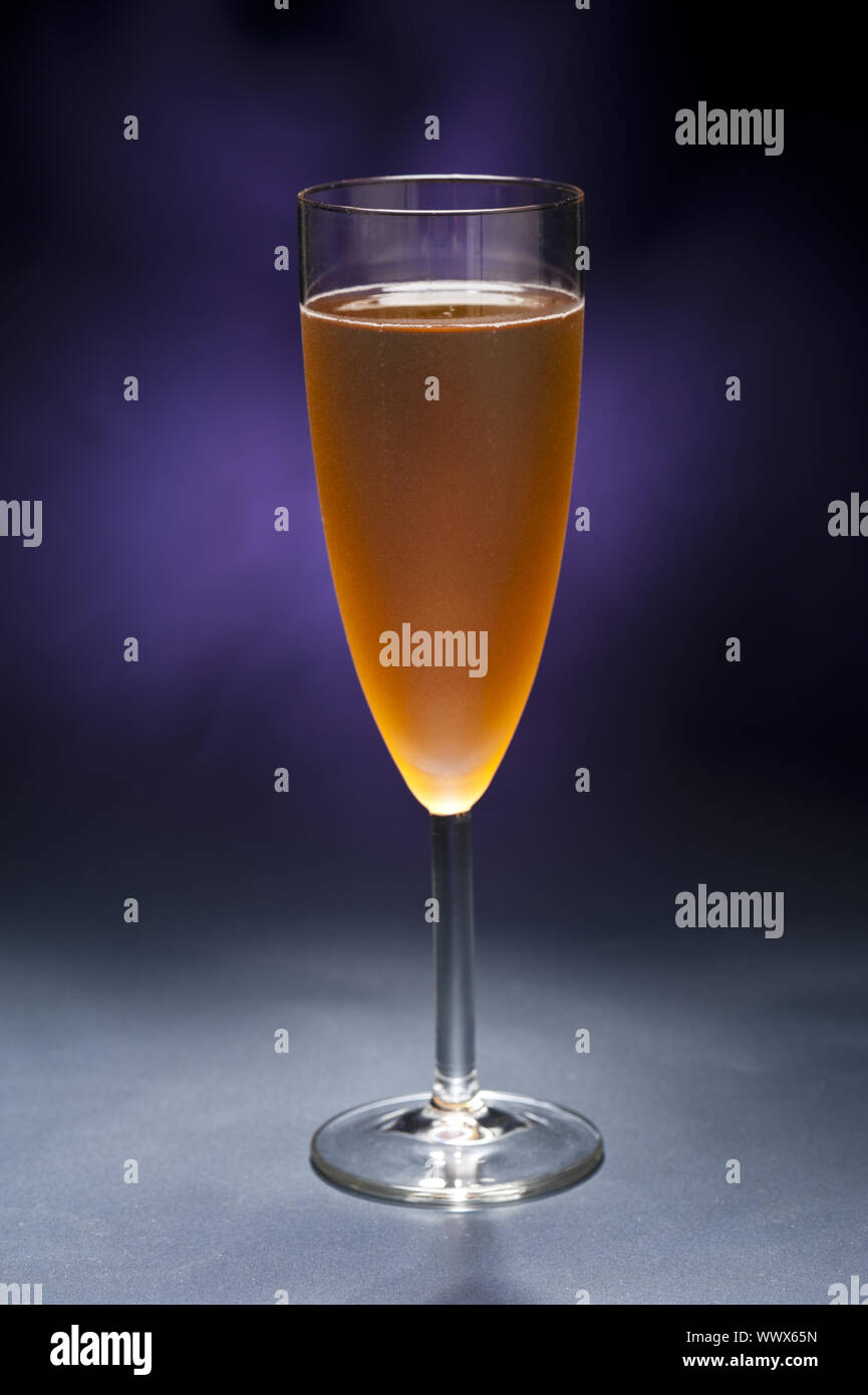 Champaign glass in front of blue purple background Stock Photo - Alamy