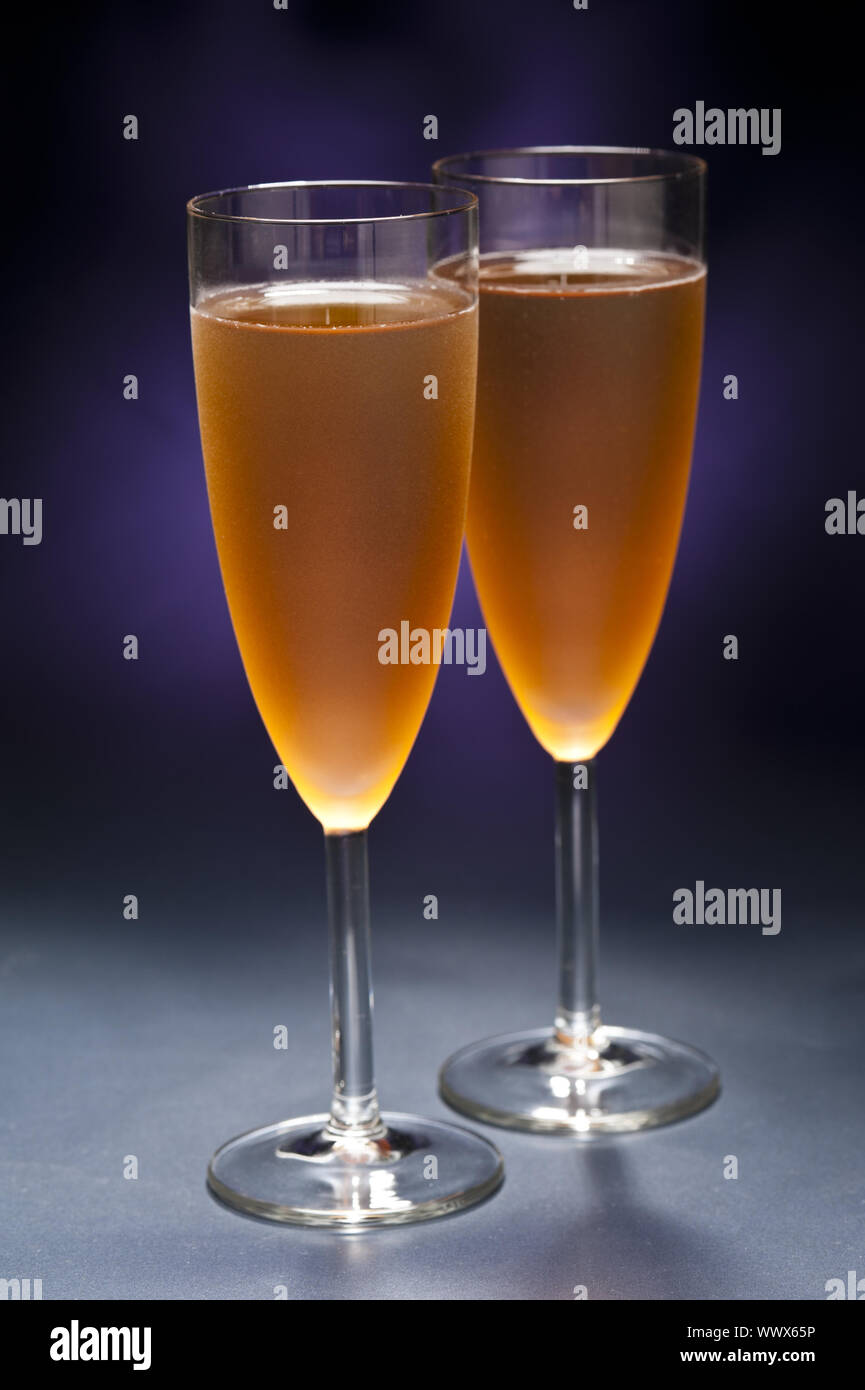 Champaign glass in front of blue purple background Stock Photo - Alamy