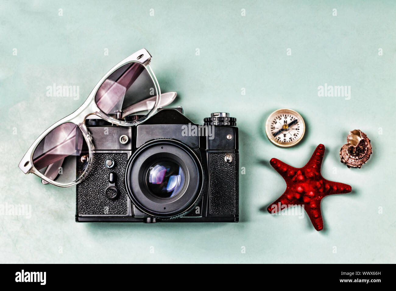 Ancient camera, compass and sea souvenirs on a blue background Stock ...