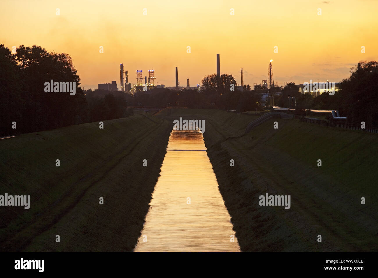 river Emscher with BP oil refinery at sunset, Gelsenkirchen, Ruhr Area ...