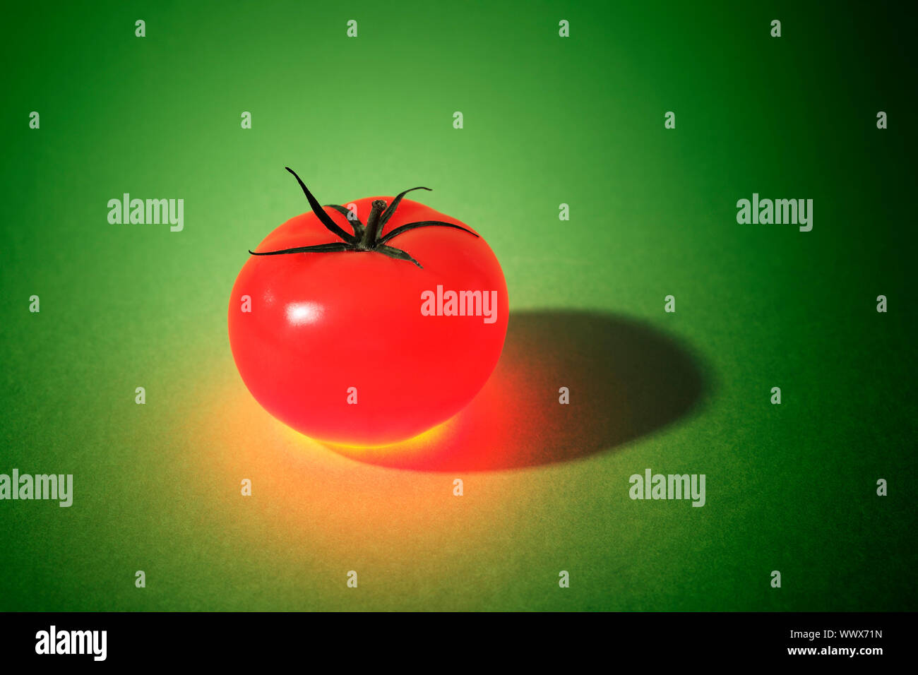 A Glowing Tomato on green background. Note that the background may ...