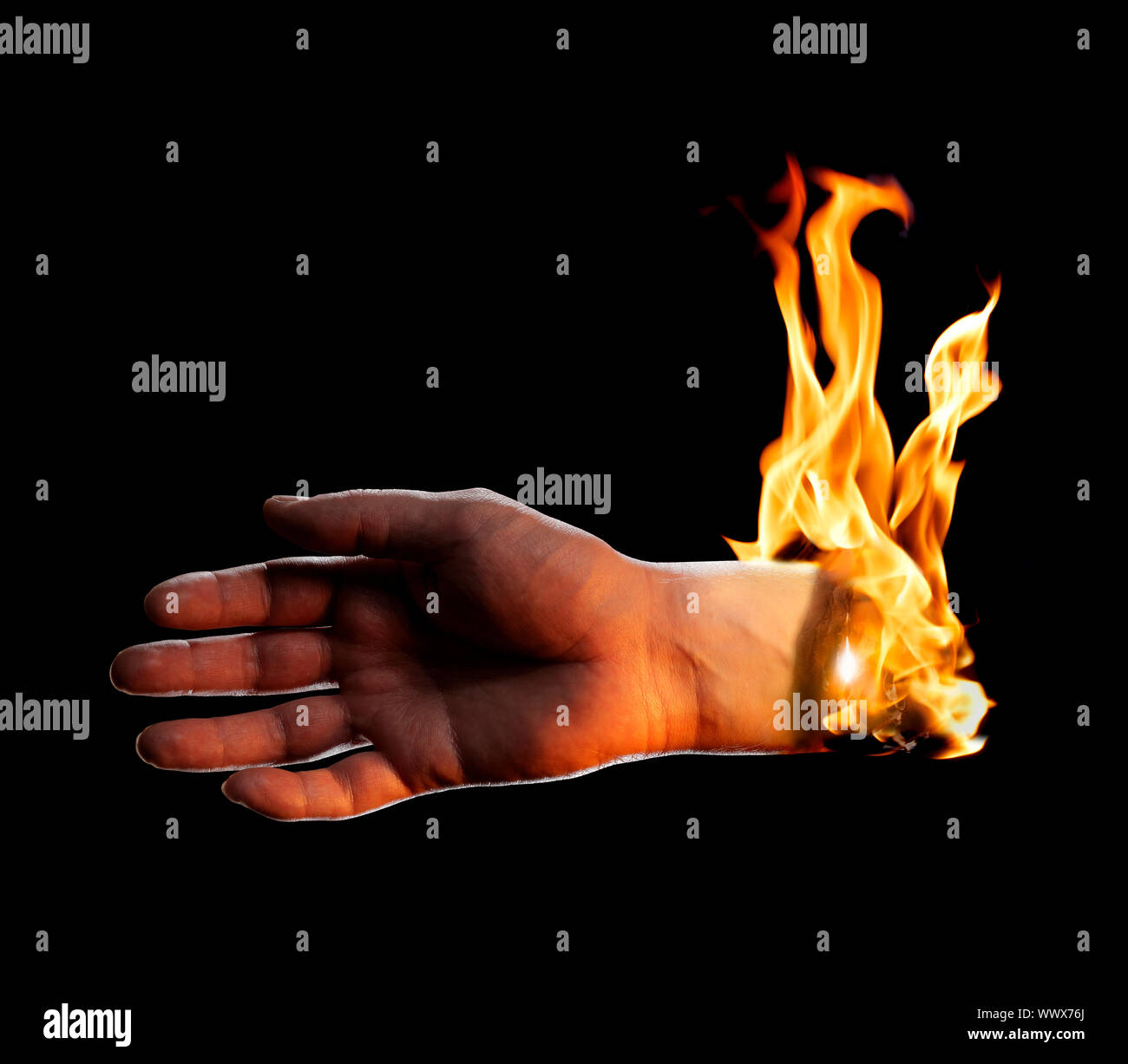 A Burning hand on black background Stock Photo - Alamy