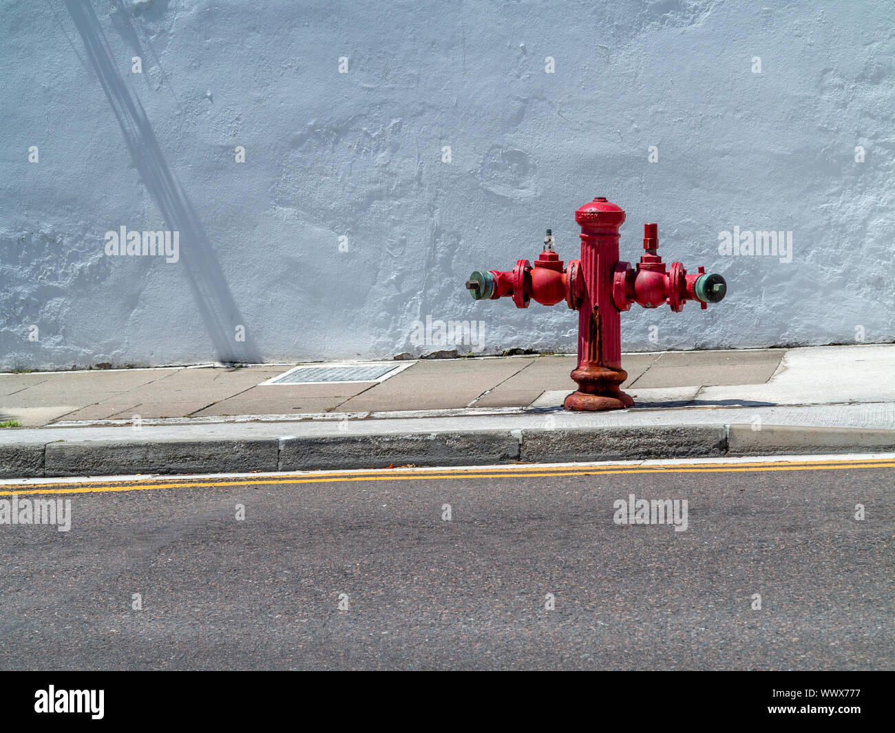 Two sided red roadside fire hydrant on a pavement in Hamilton Bermuda ...