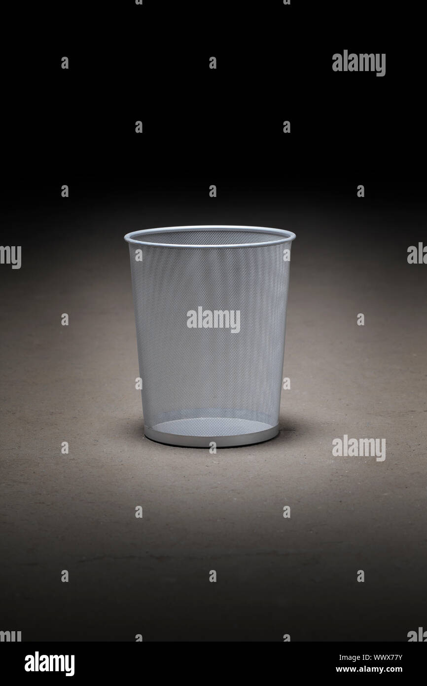Empty wastepaper basket on dirty concrete floor Stock Photo - Alamy