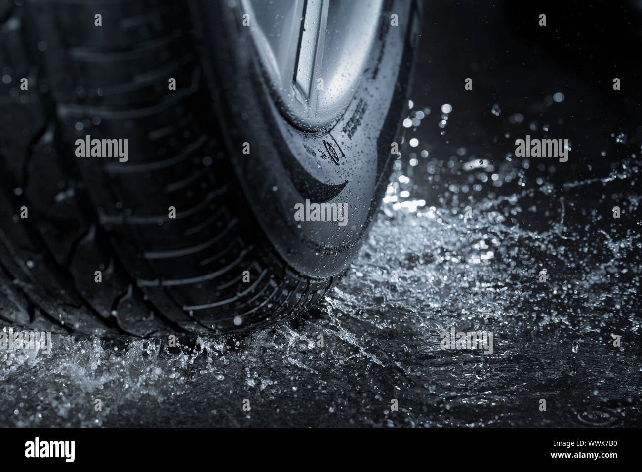 Car tire splashing in water Stock Photo - Alamy