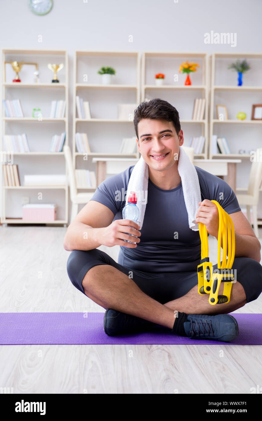 Young man exercising at home in sports and healthy lifestyle con Stock ...