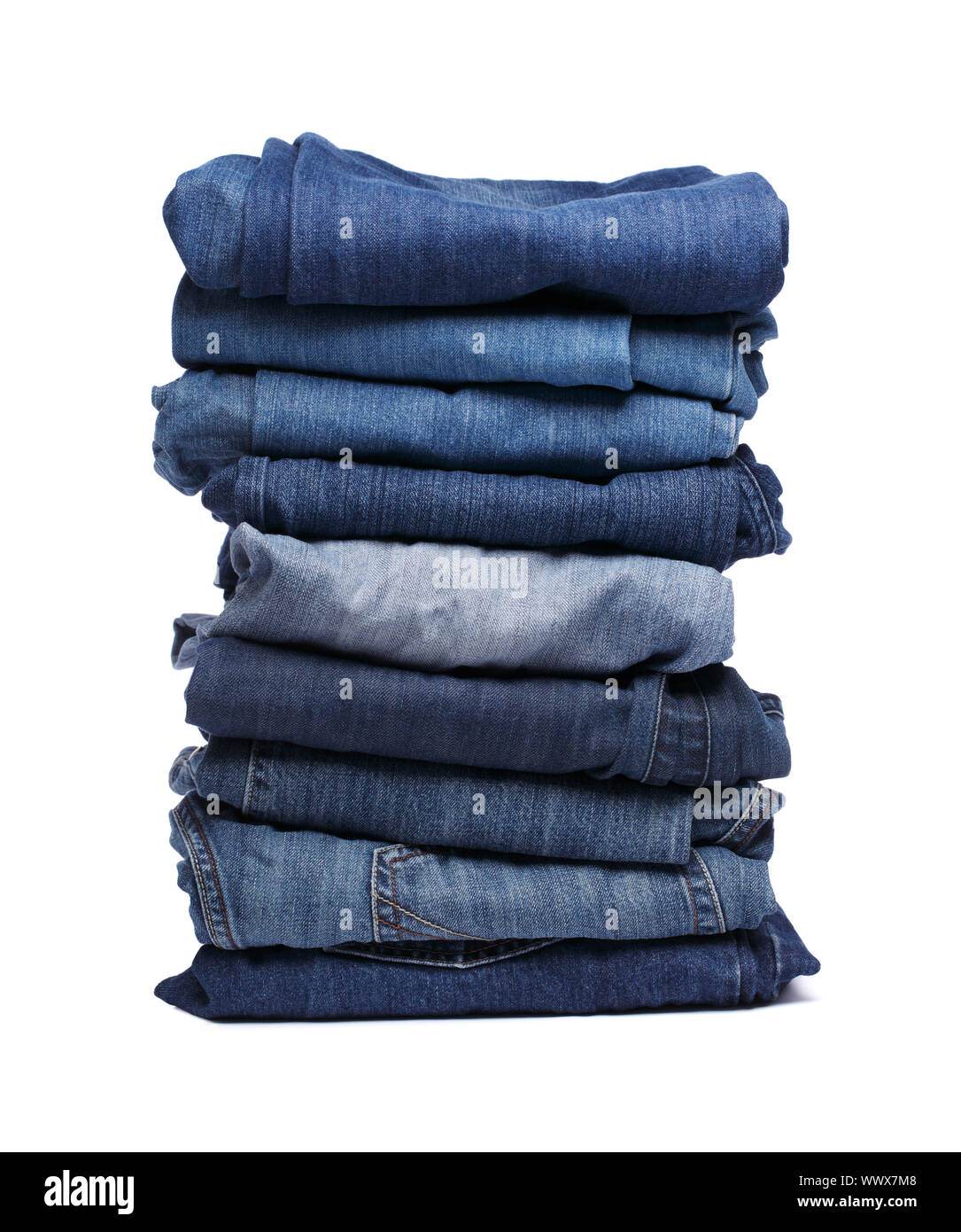 Stack of blue jeans pants isolated on white with natural shadows Stock ...