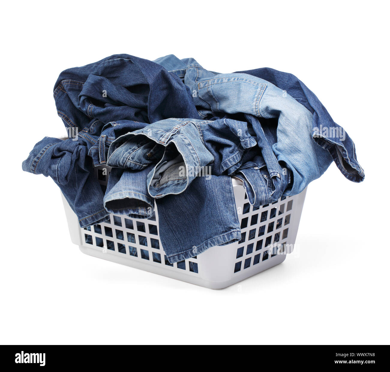 A Laundy basket filled with only jeans. Isolated on white with natural ...