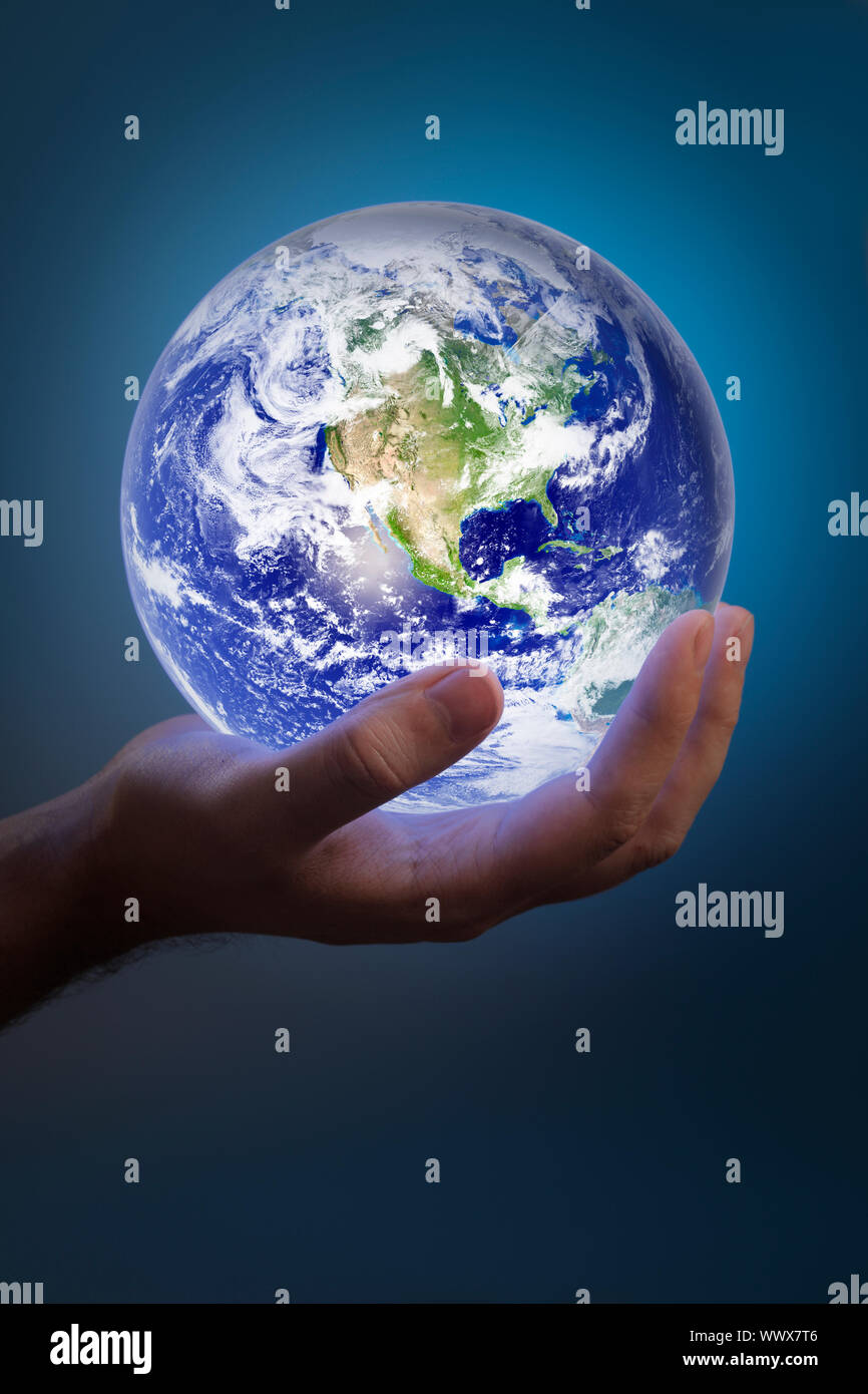 Man holding a glowing earth in his hand. Earth image provided by NASA ...