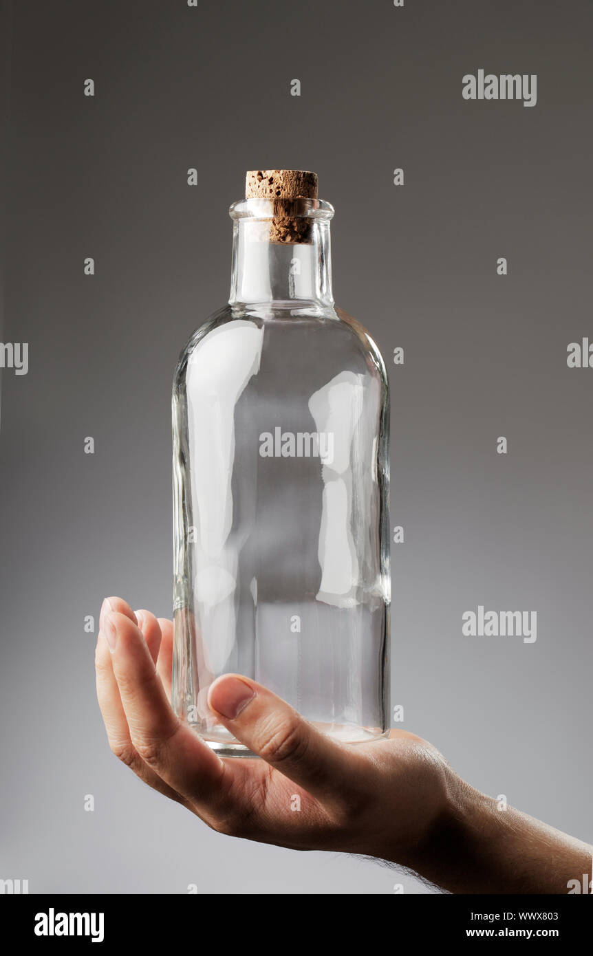Man holding an old-fashioned glass bottle in his hand Stock Photo - Alamy