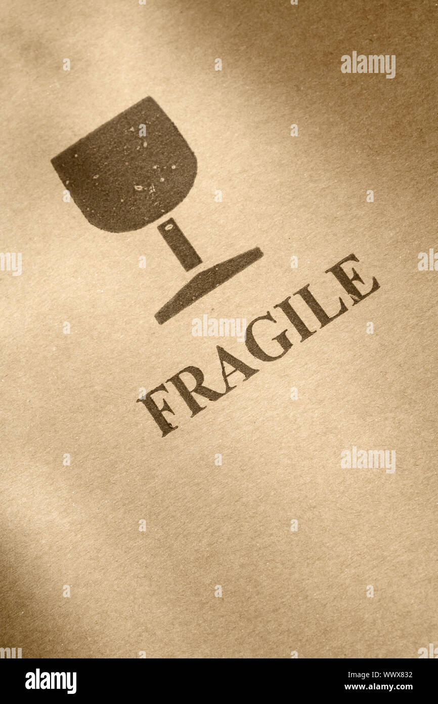 "Fragile" symbol printed on brown cardboard Stock Photo - Alamy