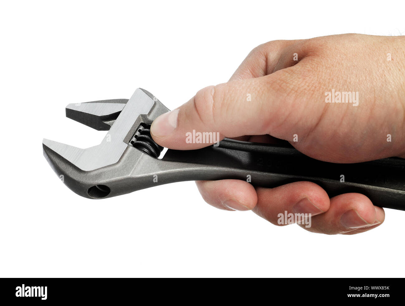 Man adjusting an adjustable wrench in his hand Stock Photo - Alamy