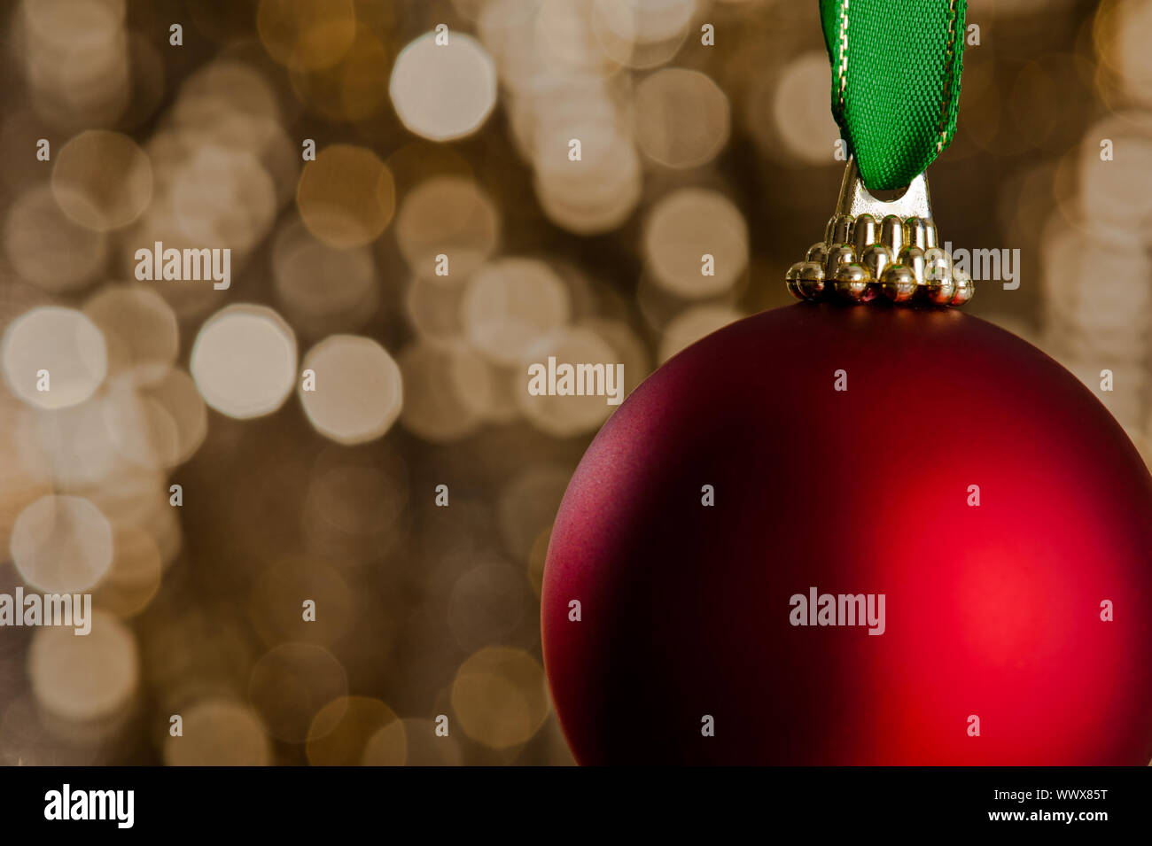 Single Christmas bauble in front of a gold glitter background Stock ...