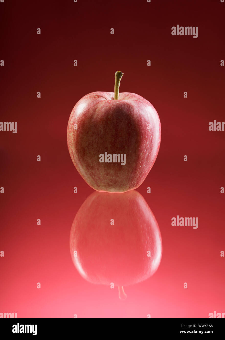 Red apple on reflective background Stock Photo - Alamy