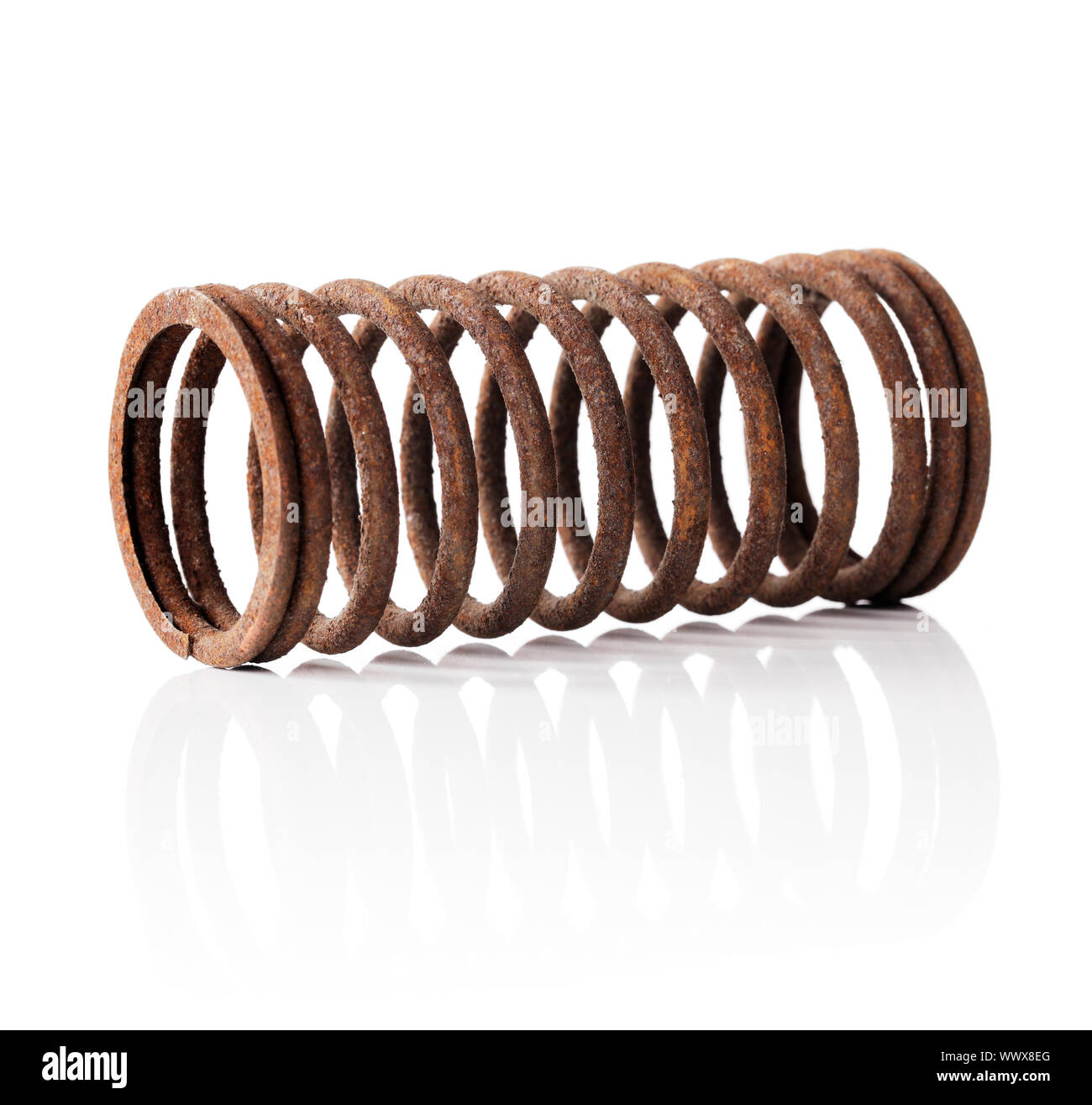 Old rusty metallic spring on white reflective background Stock Photo ...