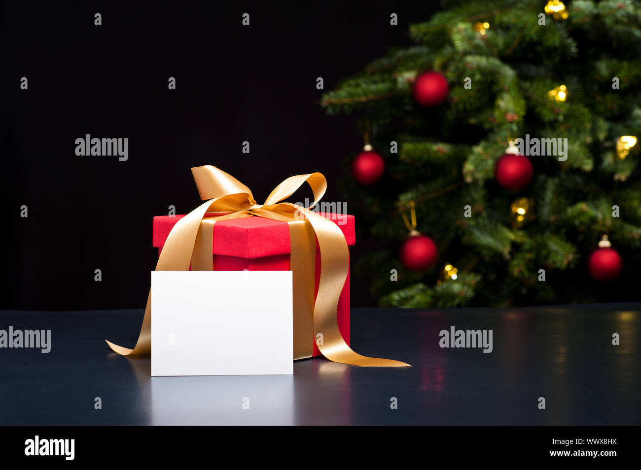 Christmas present with white card Stock Photo - Alamy
