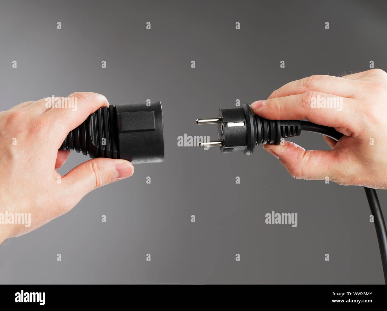 Man connecting an european shielded extension cord Stock Photo - Alamy