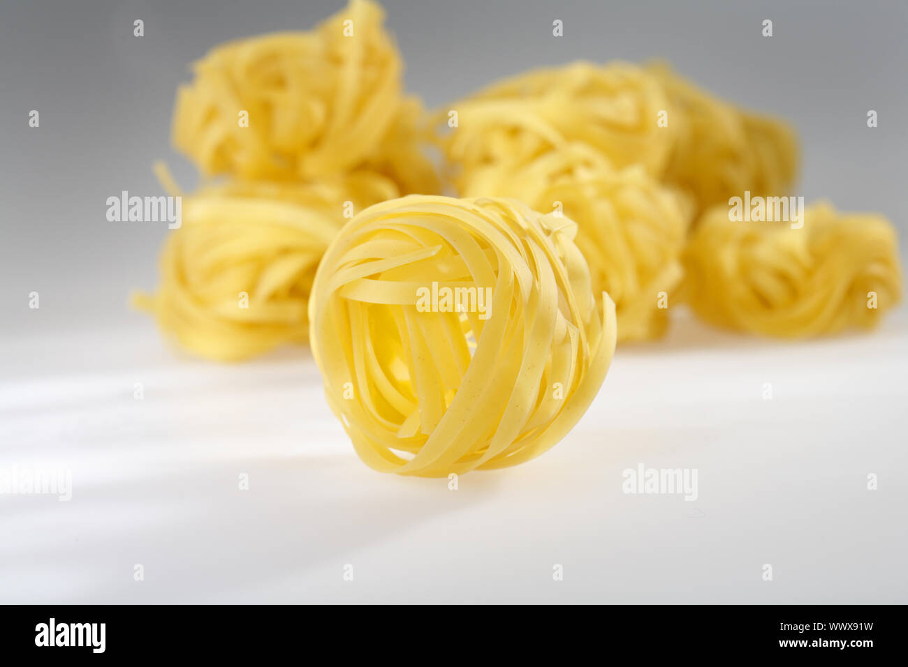 Uncooked italian pasta tagliatelle photographed using a spotlight Stock ...