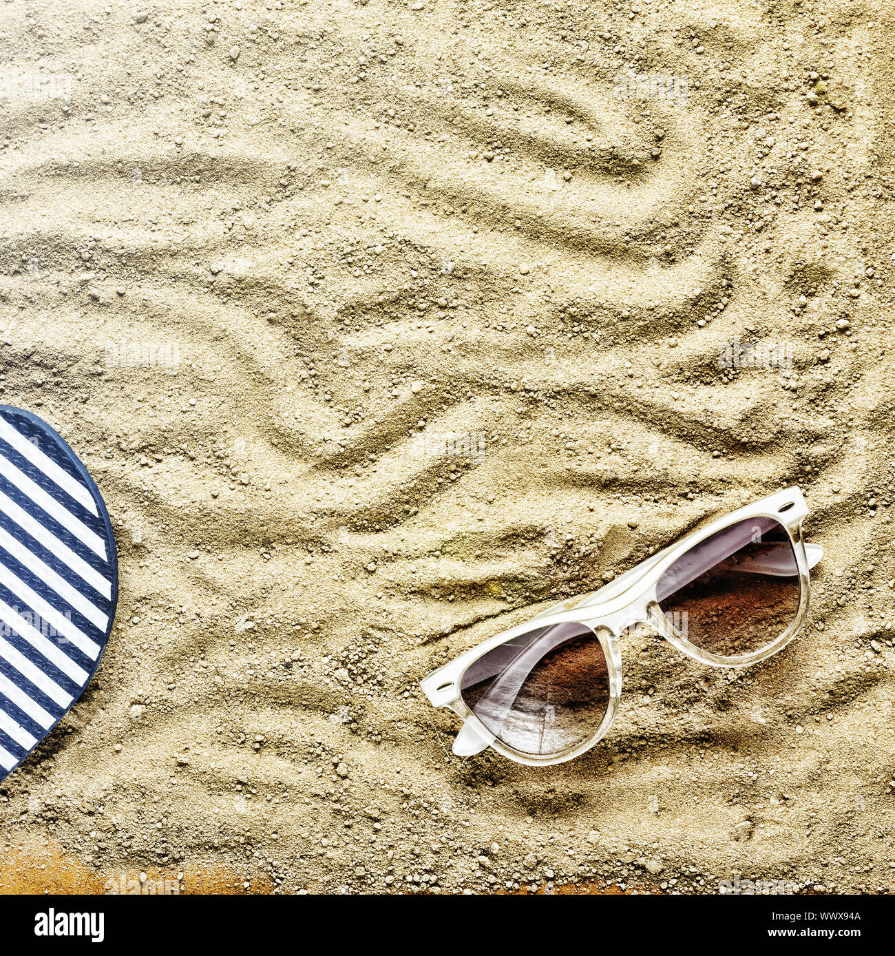 Beach background. Beach slippers and sunglasses Stock Photo - Alamy