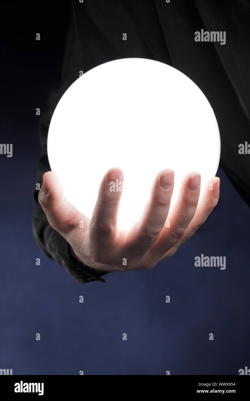 Man holding a glowing white sphere in his hand Stock Photo - Alamy
