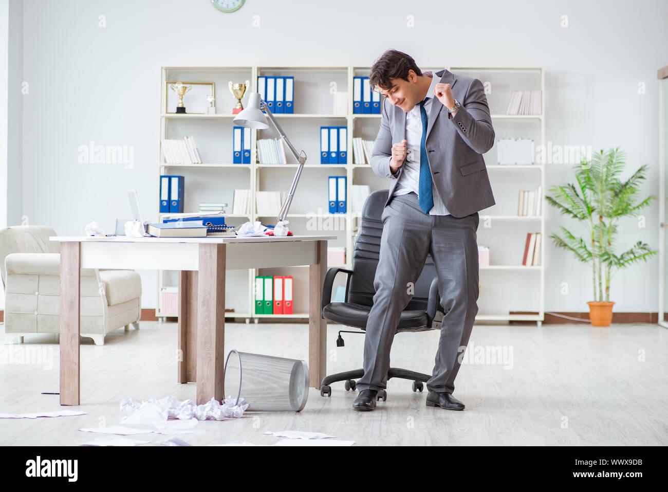 Businessman having fun taking a break in the office at work Stock Photo ...
