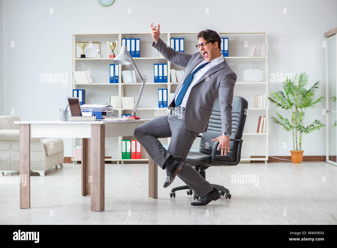 Businessman having fun taking a break in the office at work Stock Photo ...