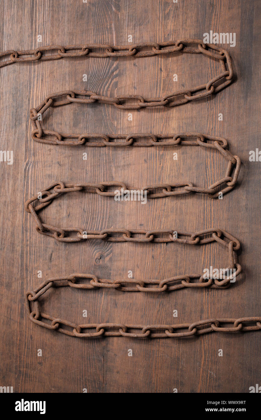 Old rusty chain on wooden background Stock Photo - Alamy
