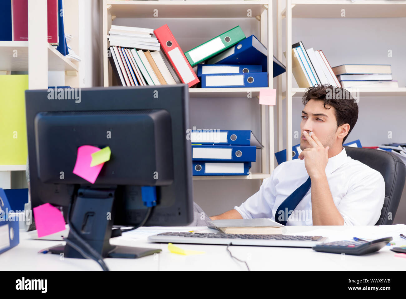 Businessman working in the office with piles of books and papers Stock ...