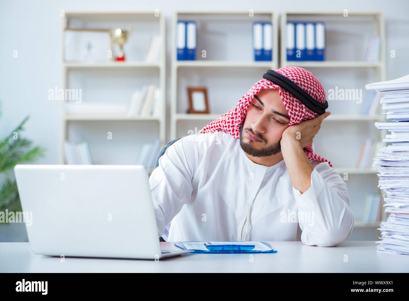 Arab businessman working in the office doing paperwork with a pi Stock ...
