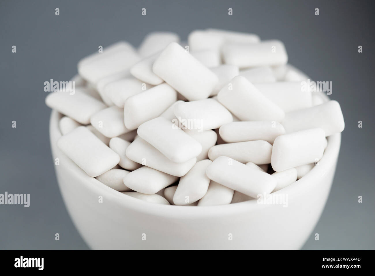 White rectangular chewing gum in a small white bowl Stock Photo - Alamy