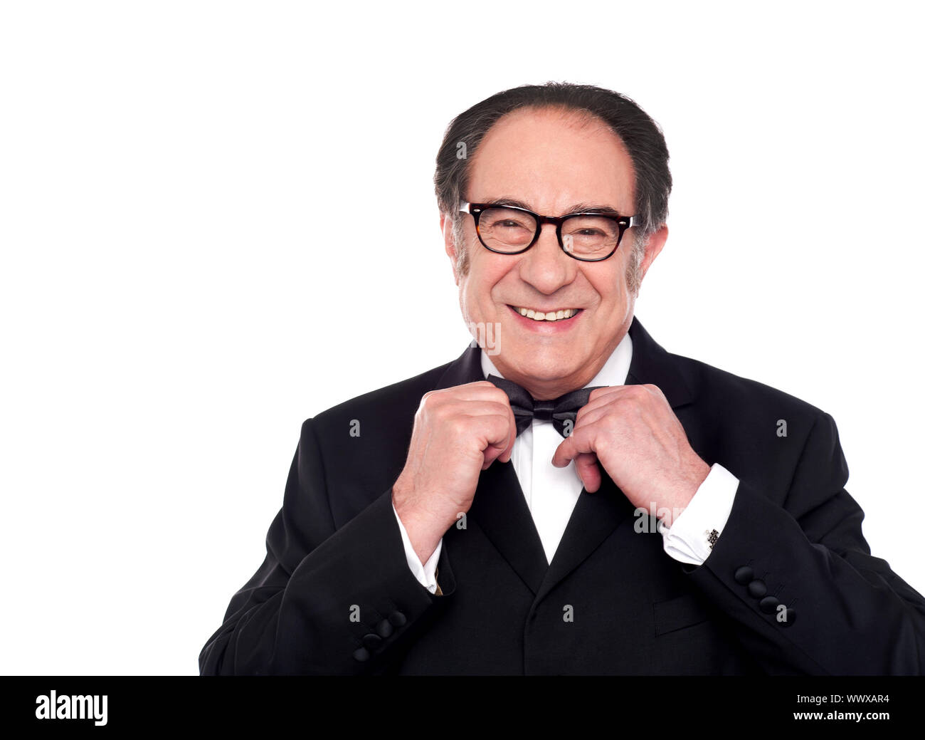 Cheerful old man in classical tuxedo adjusting his bow Stock Photo - Alamy