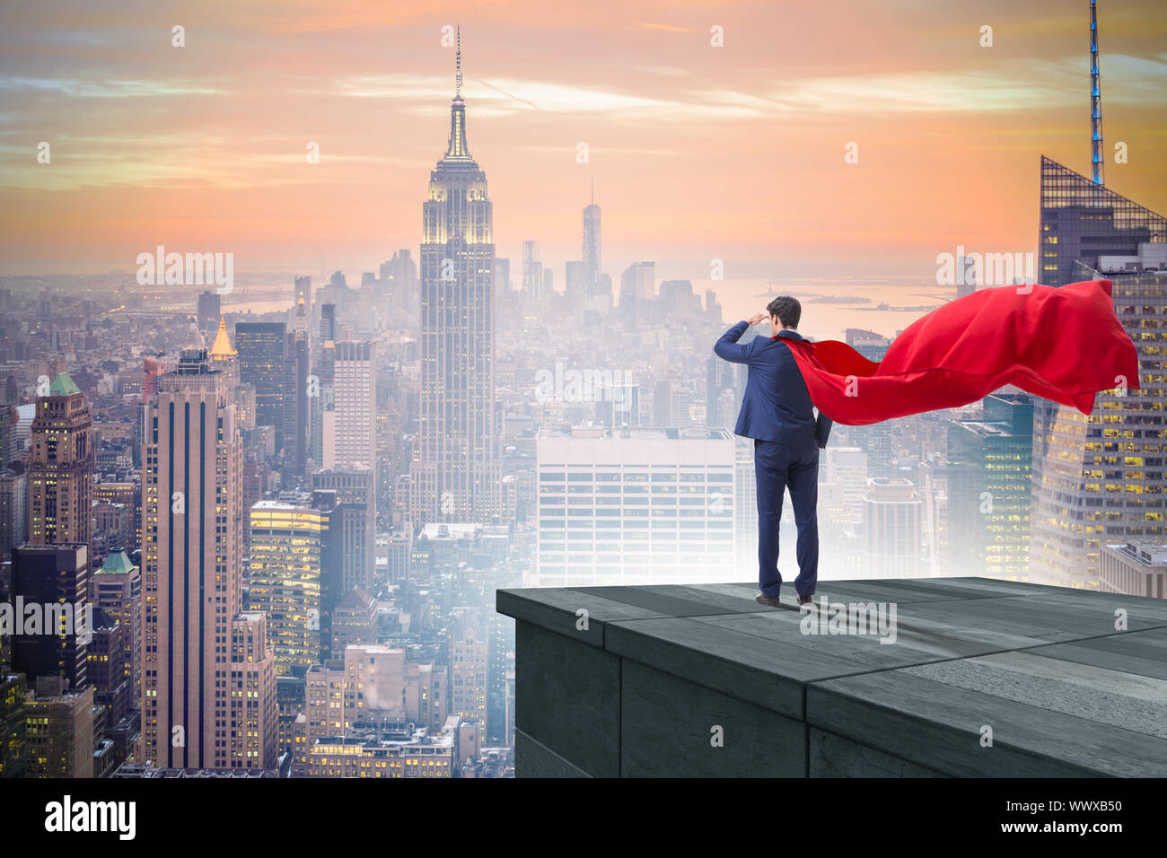 Super hero businessman on top of building ready for challenge Stock ...