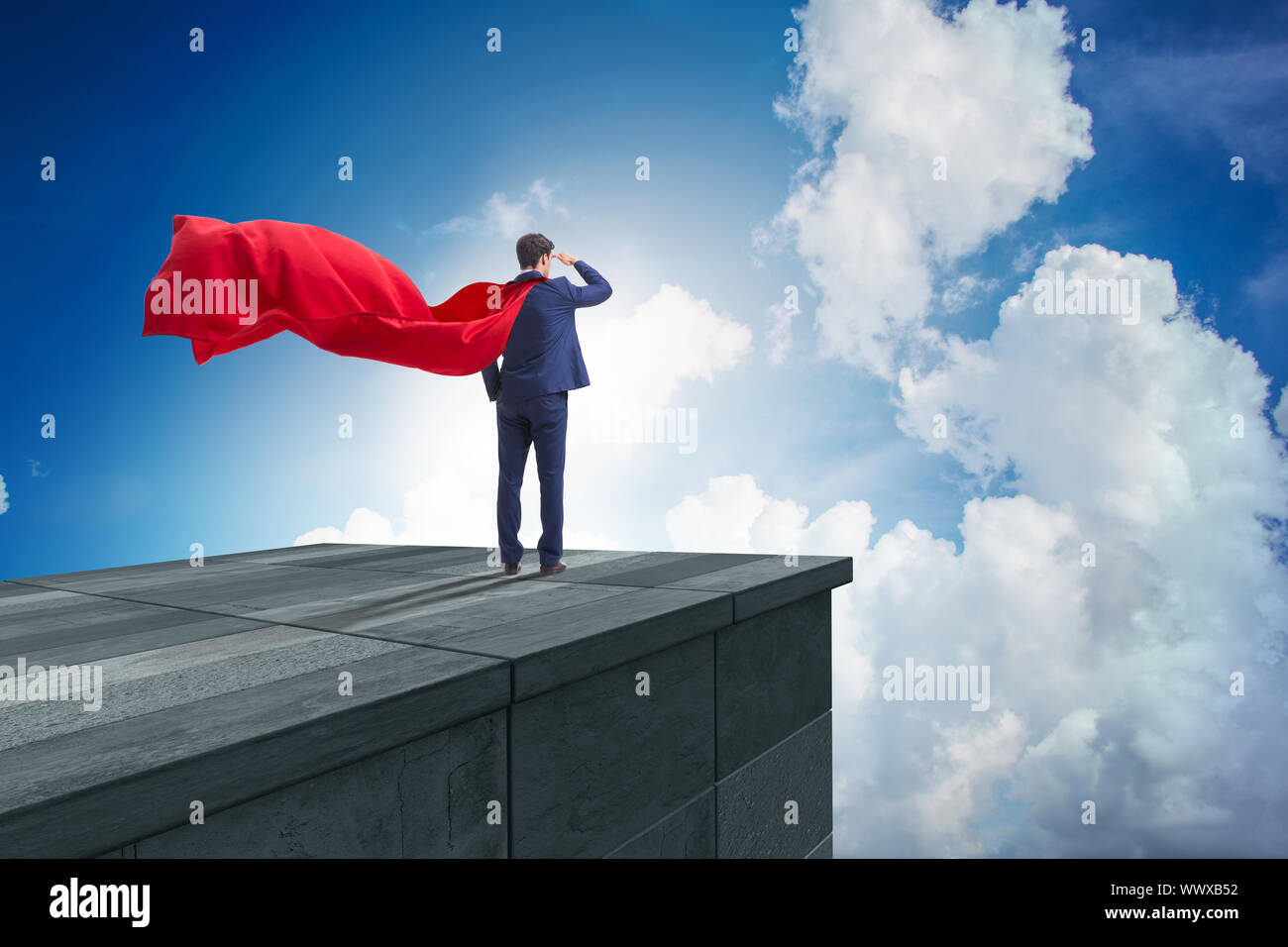 Super hero businessman on top of building ready for challenge Stock ...