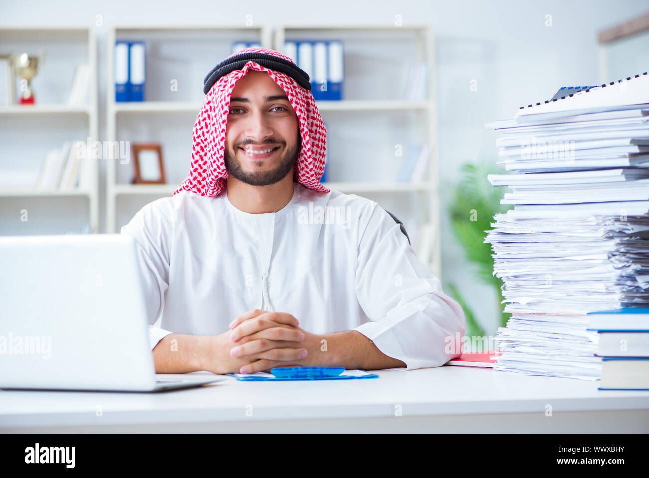 Arab businessman working in the office doing paperwork with a pi Stock ...
