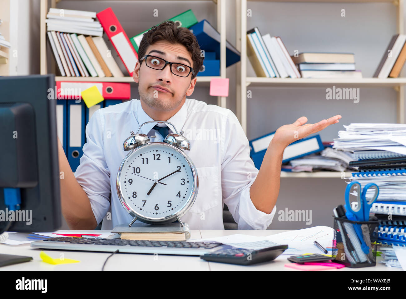 Businessman working in the office with piles of books and papers Stock ...