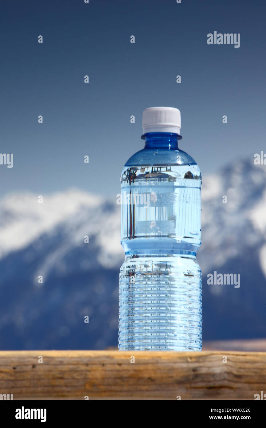 water in cup mountains on background Stock Photo - Alamy