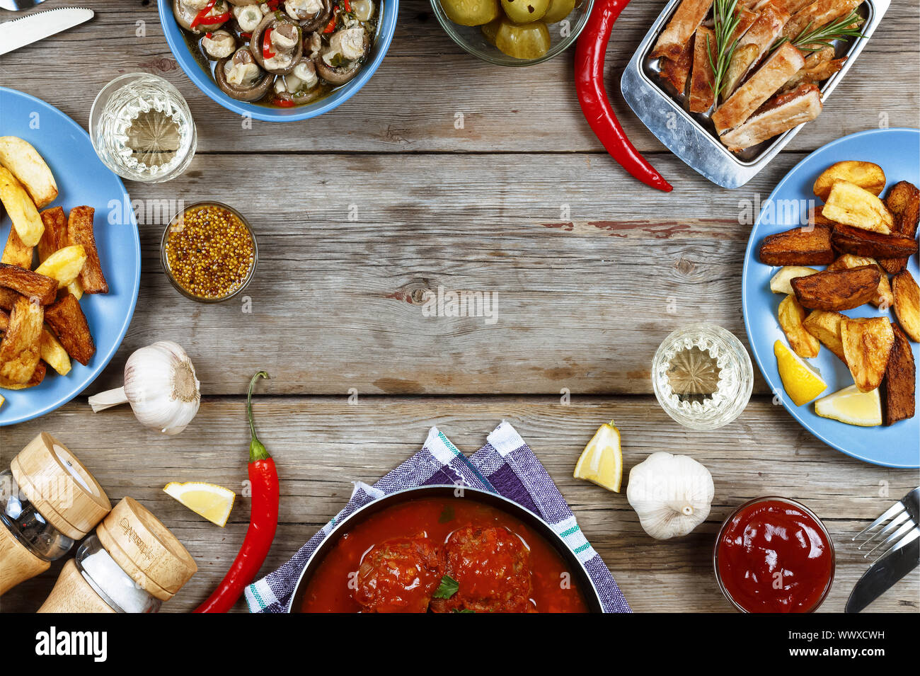 Dining table with a variety of meals and snacks. Rustic style ...