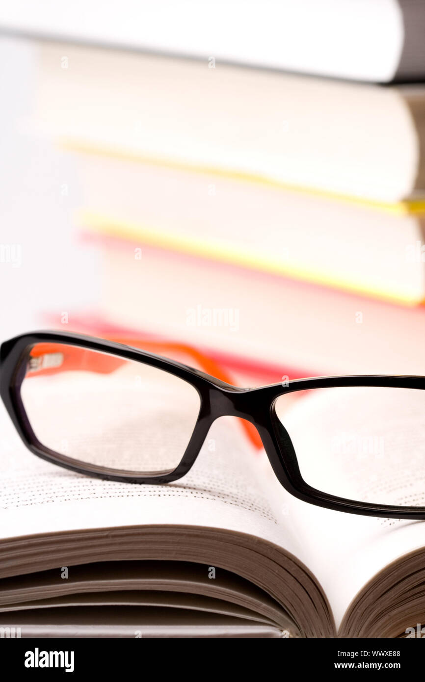 books and glasses closeup on white background Stock Photo - Alamy