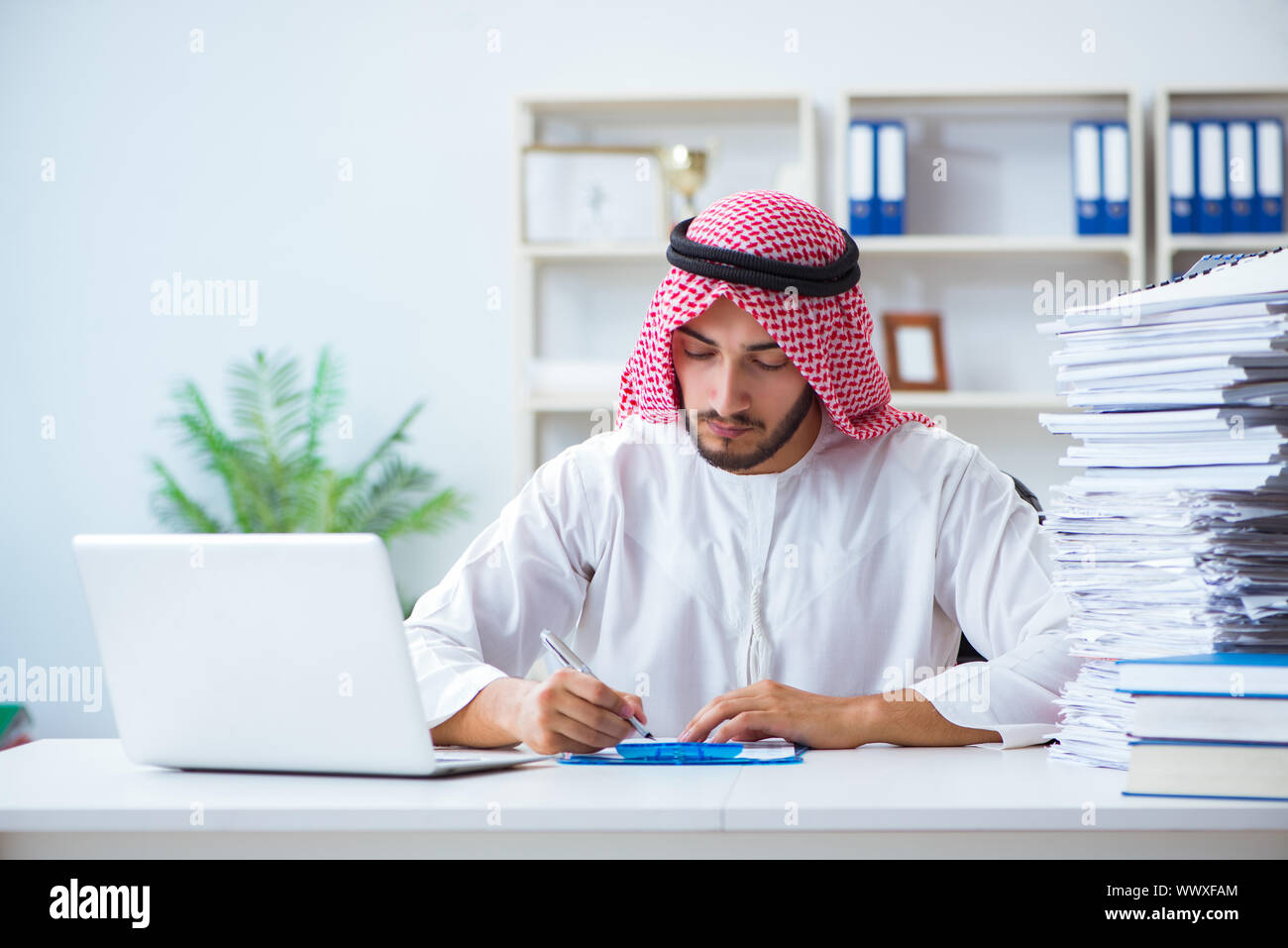 Arab businessman working in the office doing paperwork with a pi Stock ...