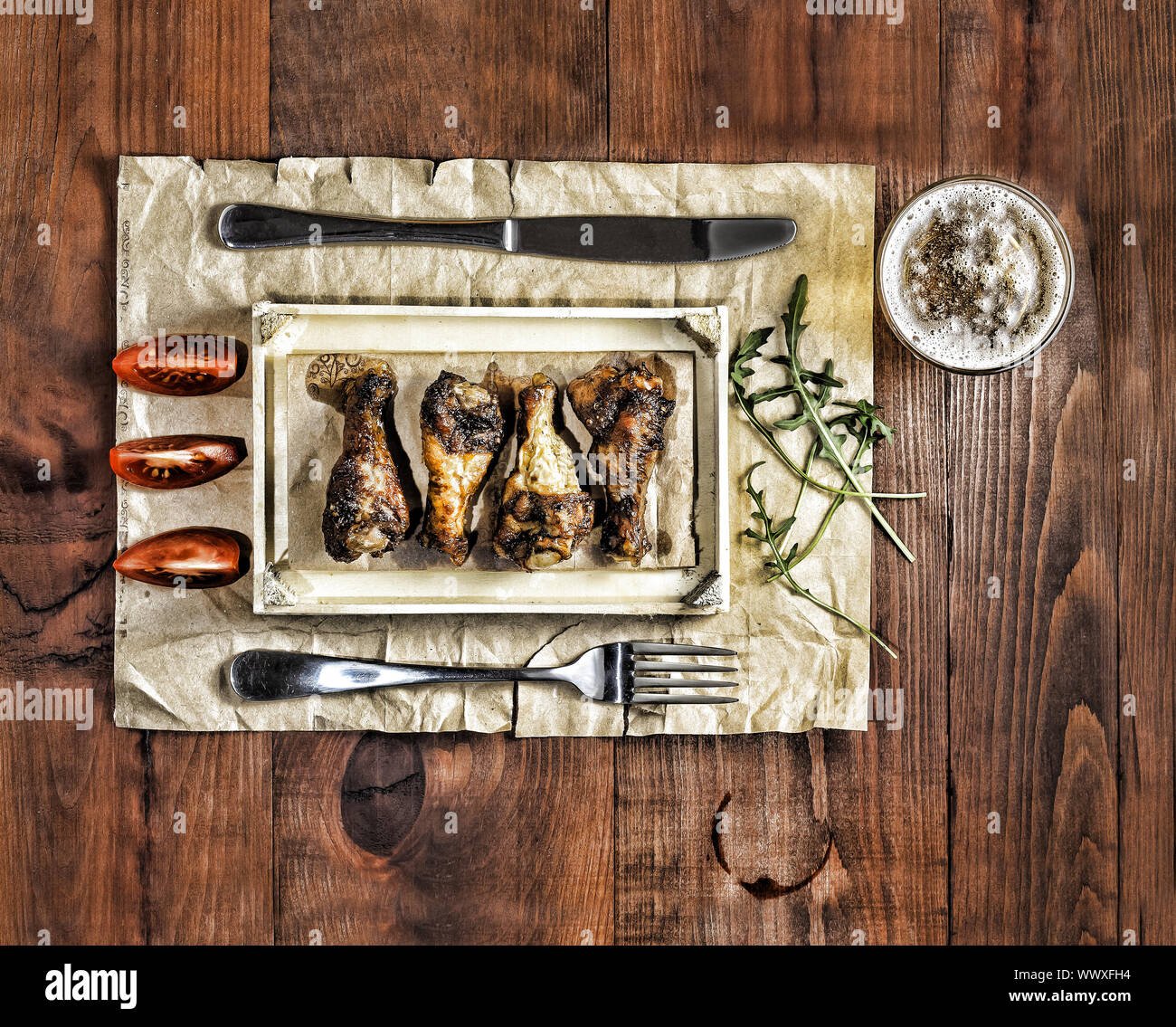 Beer and chicken legs with barbecue Stock Photo - Alamy