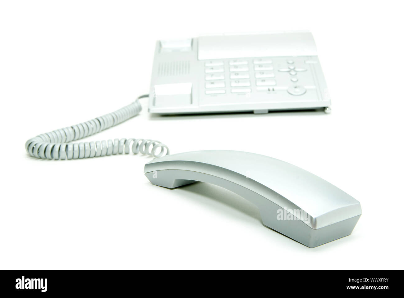 grey office telephone on a white background Stock Photo - Alamy