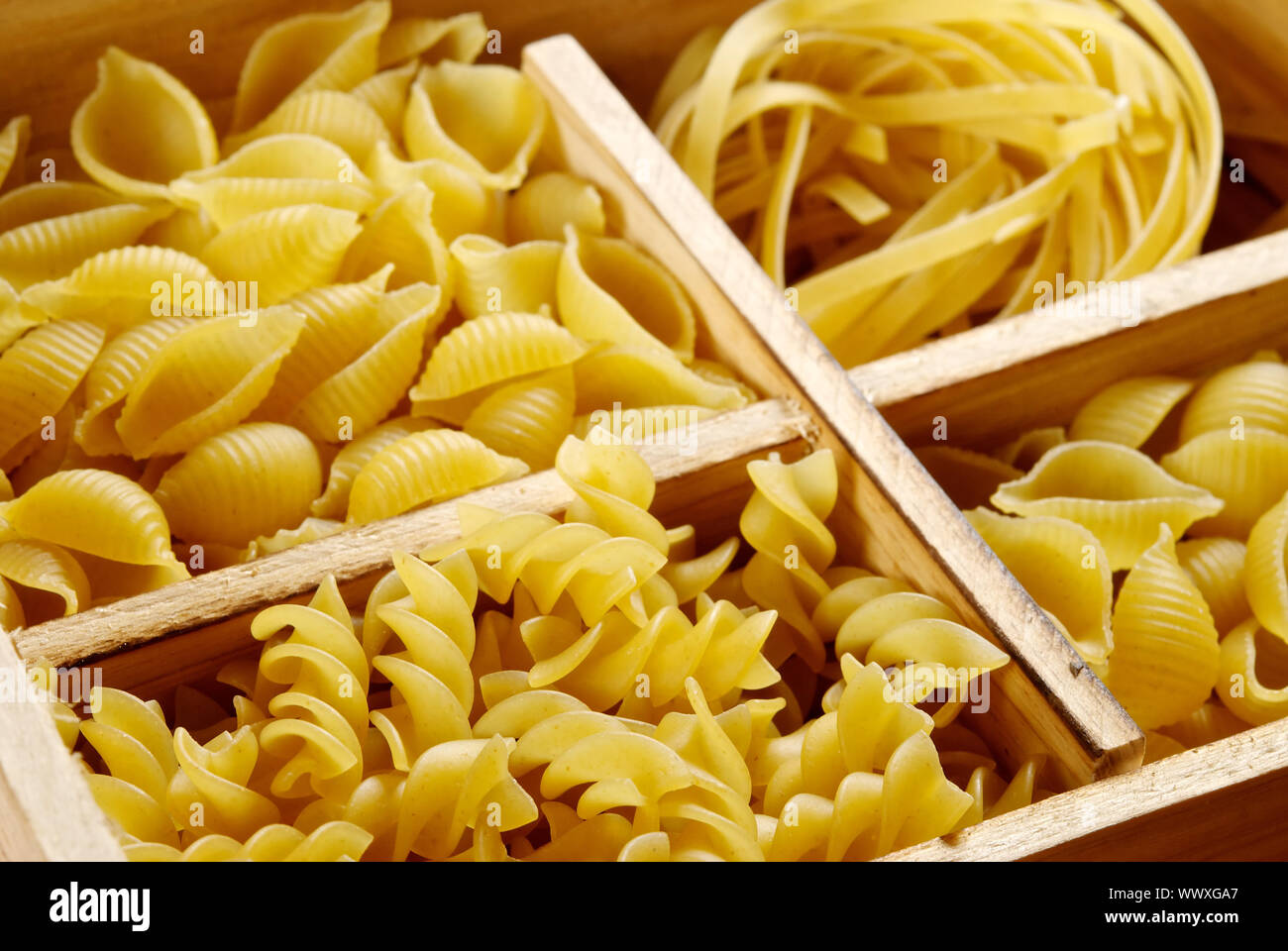 Set of four varieties of pasta in a wooden box Stock Photo - Alamy