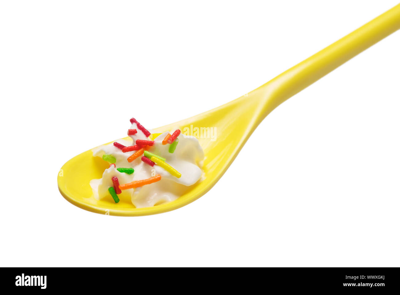 Teaspoon full of cream closeup, isolated on white background. With ...