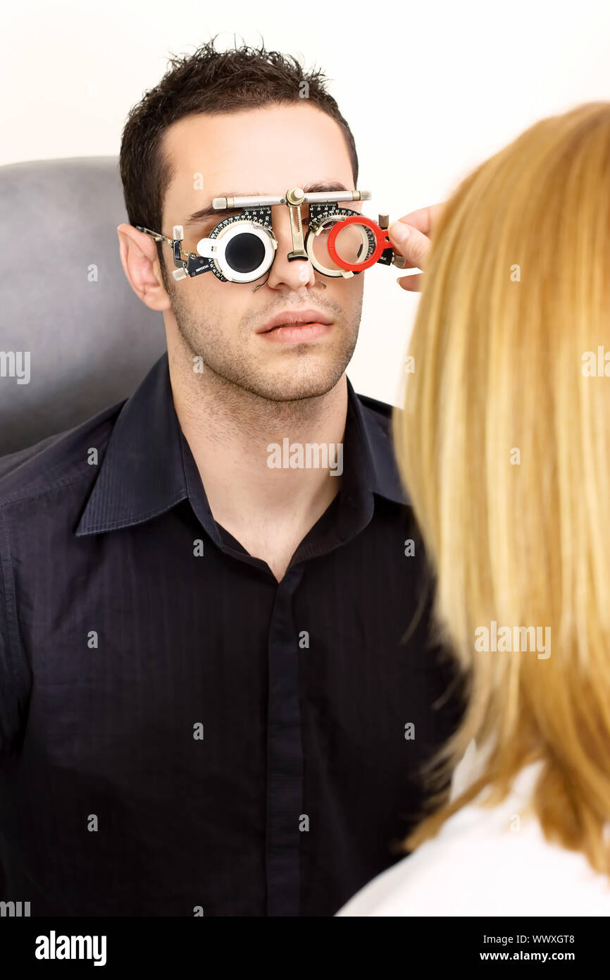 Male patient on medical attendance at the optometrist, wearing trial ...