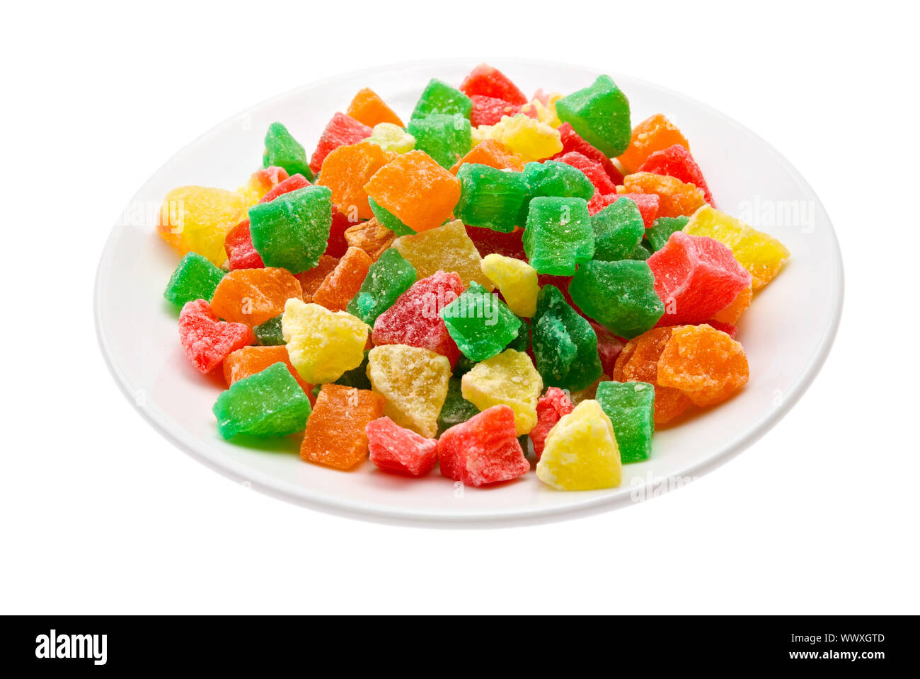 Sweet candied fruit on a saucer isolated on a white background with ...