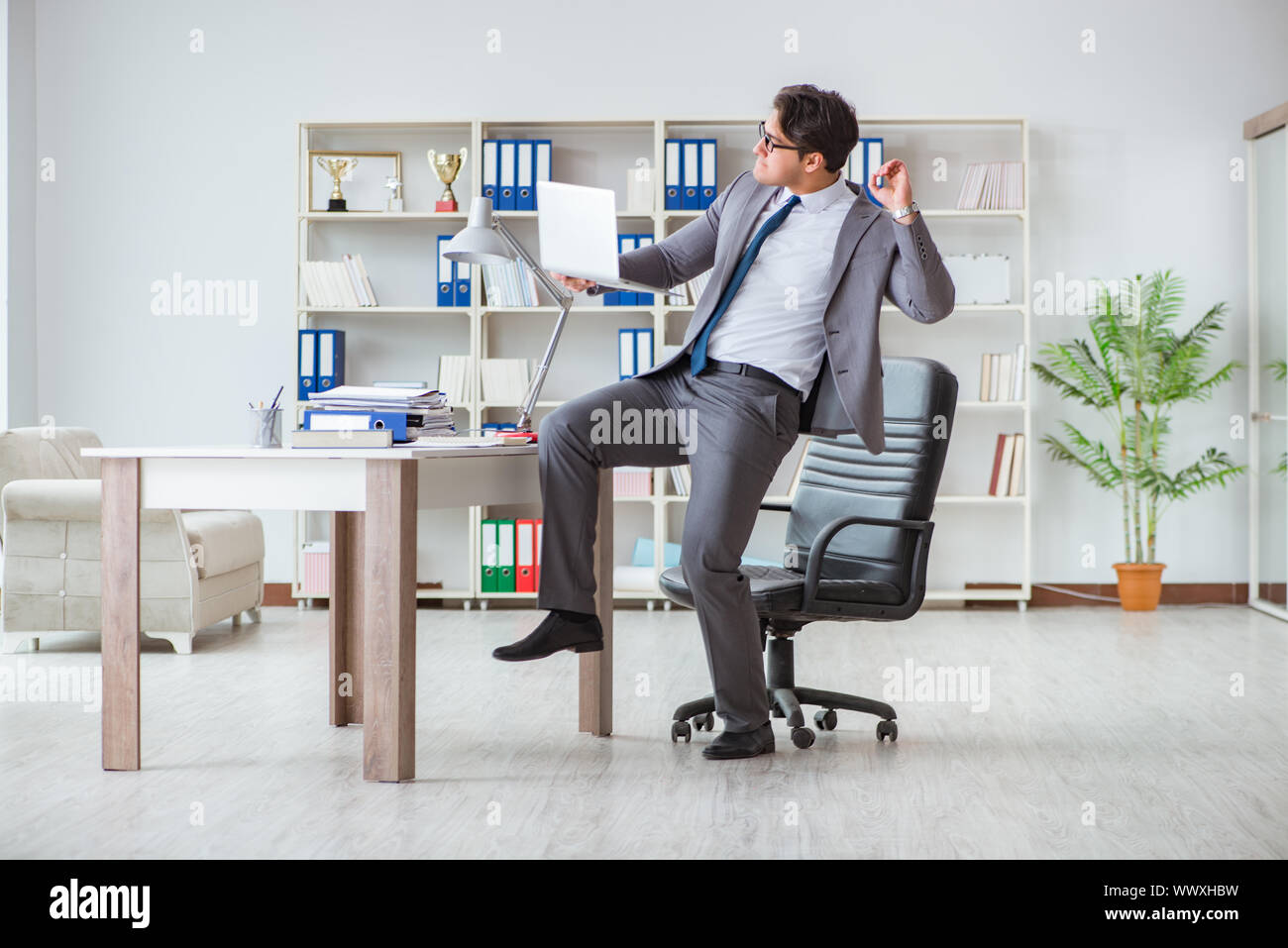 Businessman having fun taking a break in the office at work Stock Photo ...