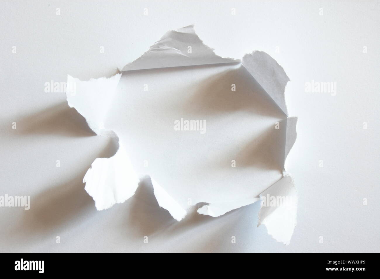 hole with copyspace in blank sheet of paper Stock Photo - Alamy